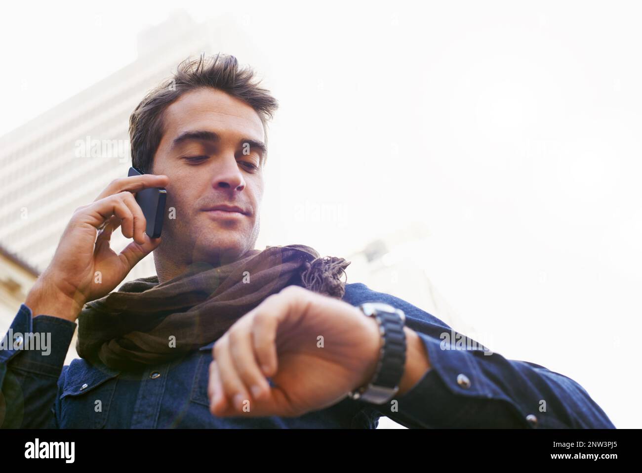 Hes always got some time..... Low angle shot of a man chekcing his ...