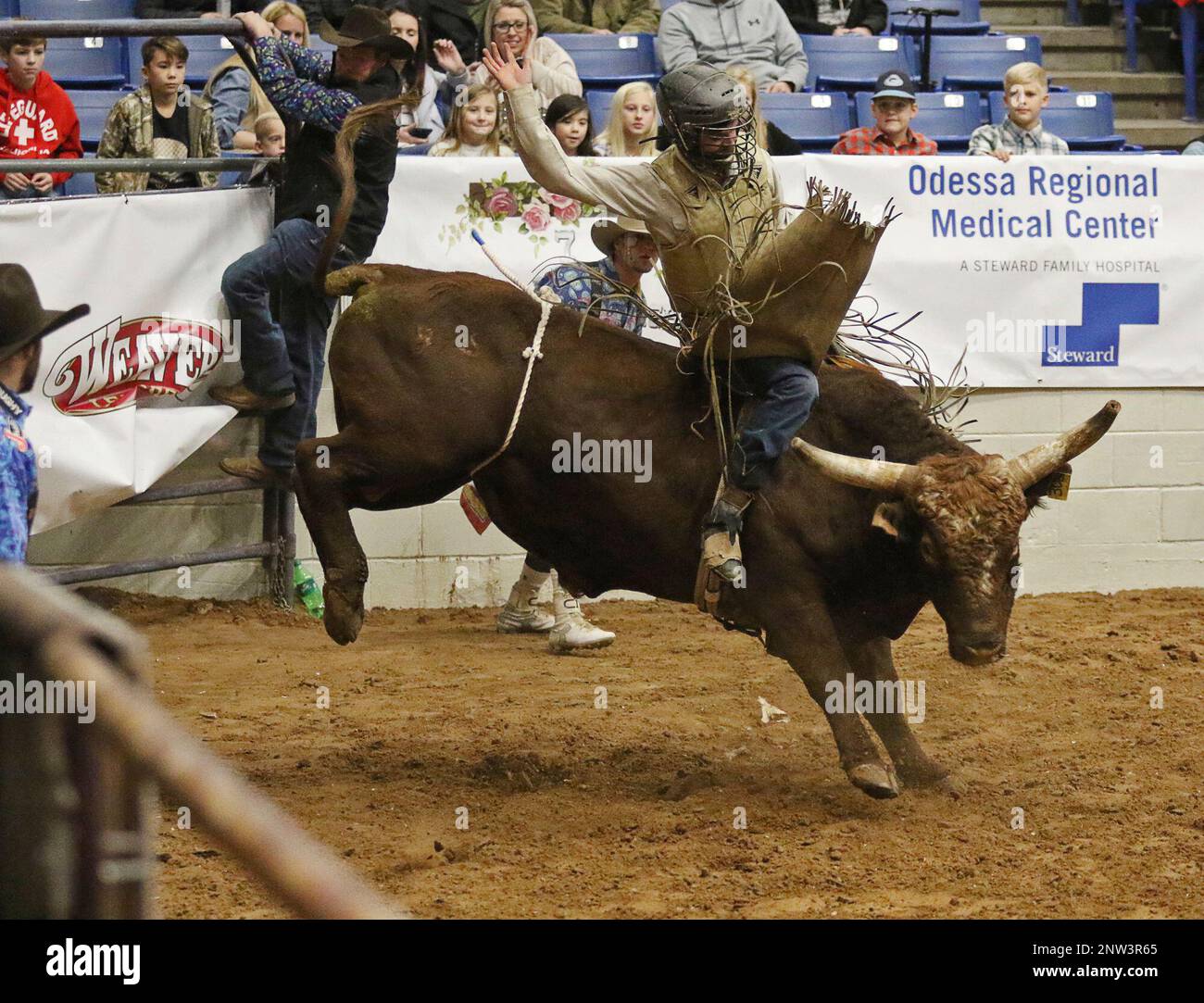 Denton Fugate competes in bull riding during the SandHills Stock Show ...