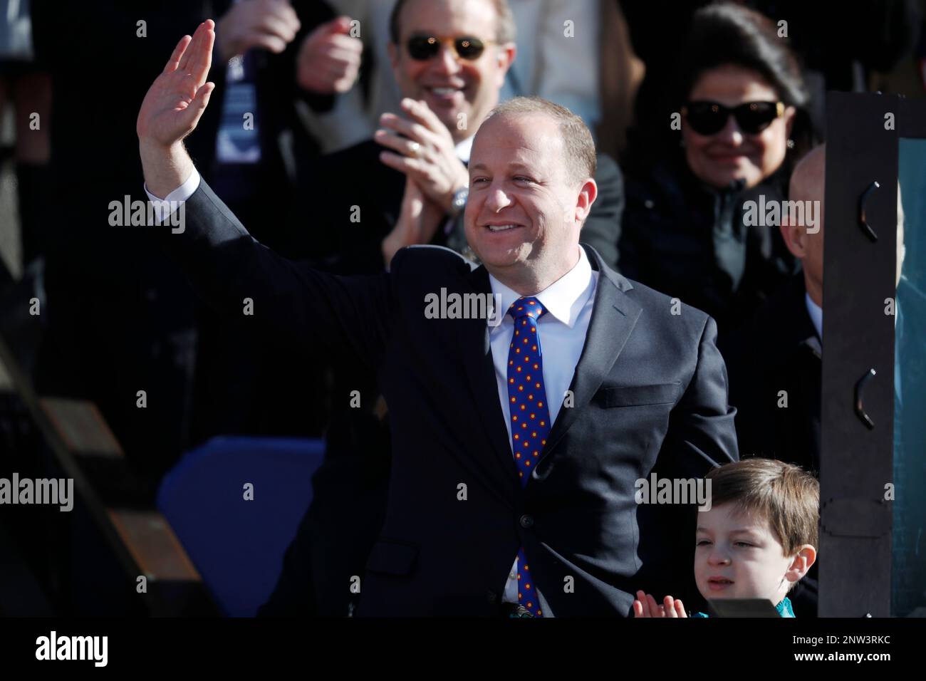 Colorado Gov. Jared Polis, left, joins his 7-year-old son, Caspian, in ...
