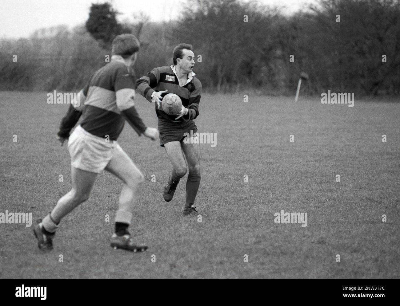 1980s, historical, amateur rugby union, a wingback about to pass the ...