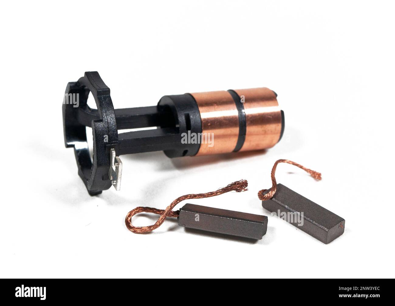 Car alternator slip rings next to graphite brushes isolated on white ...
