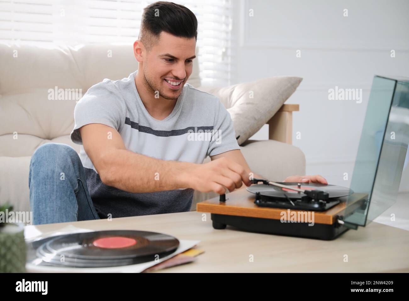 Happy man listening to music with turntable at home Stock Photo - Alamy