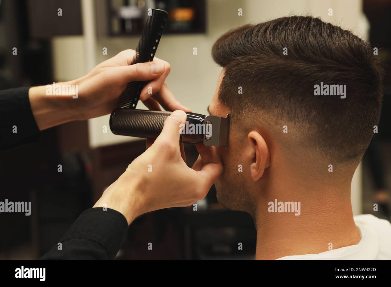 Professional hairdresser making stylish haircut in salon, closeup Stock ...