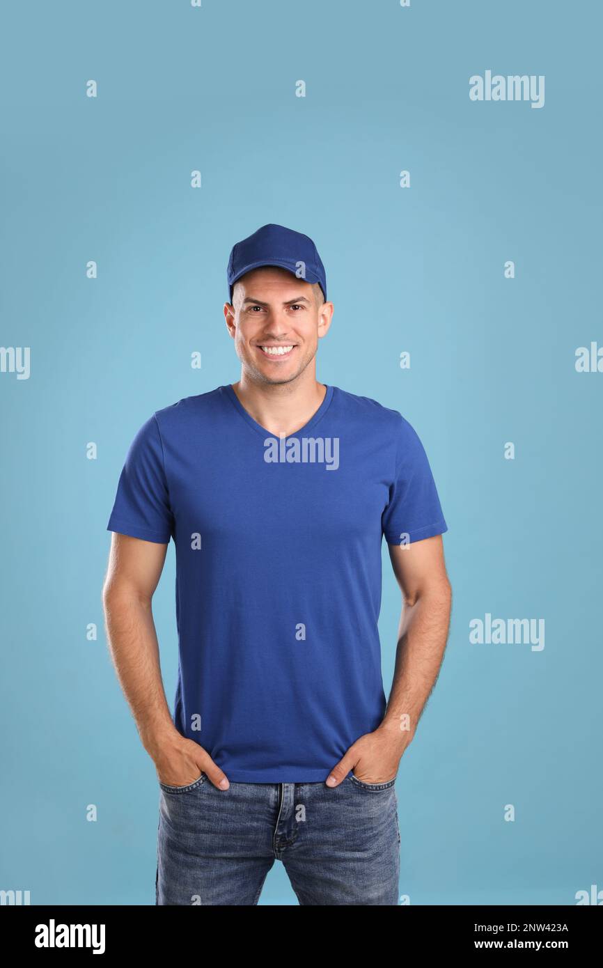 Happy man in cap and tshirt on light blue background. Mockup for design ...