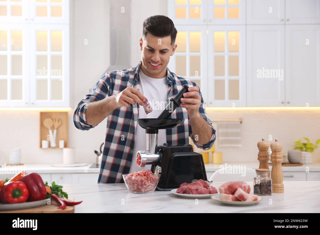 Man using modern meat grinder in kitchen Stock Photo - Alamy
