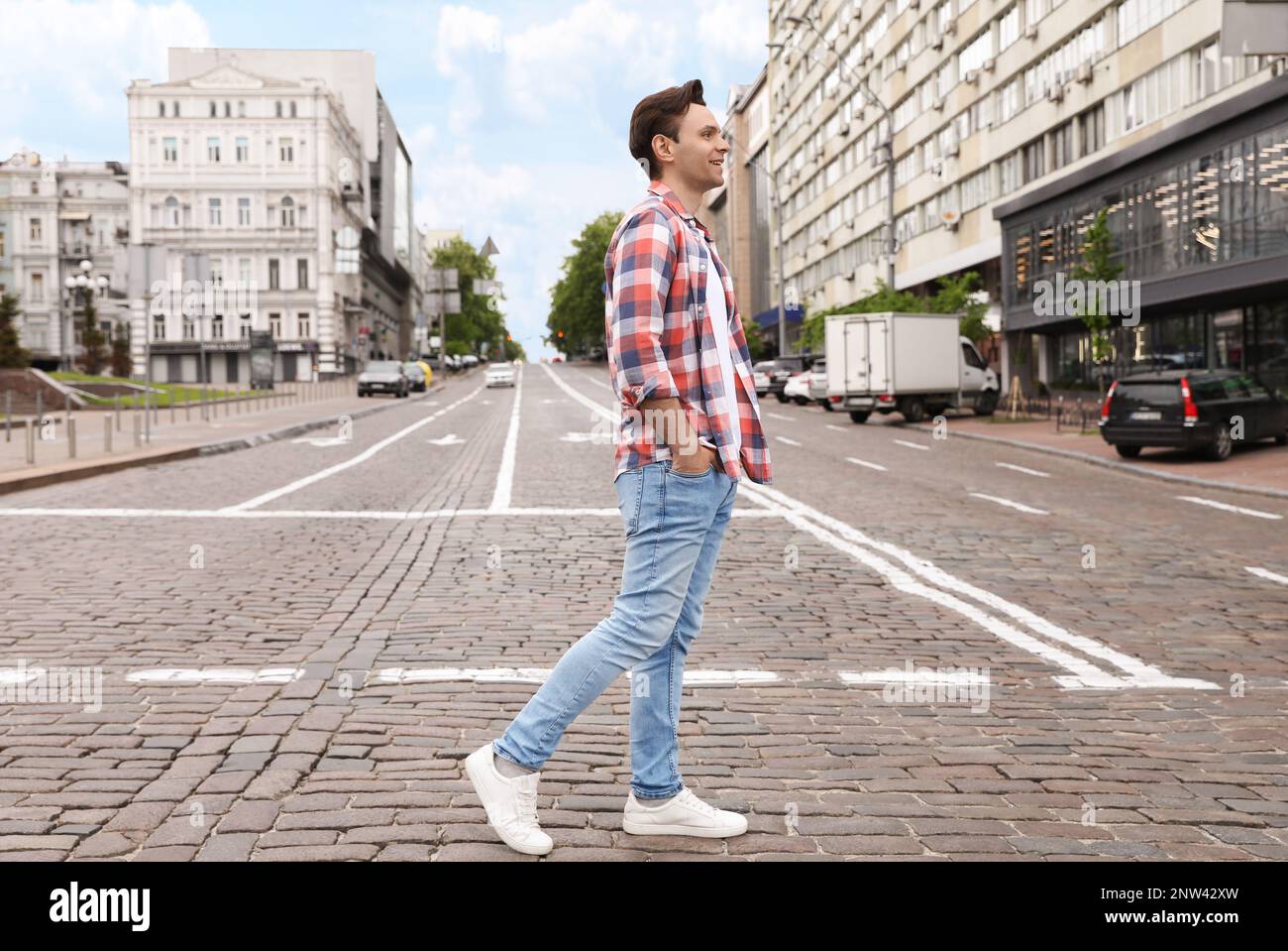 Young man crossing street. Traffic rules and regulations Stock Photo ...