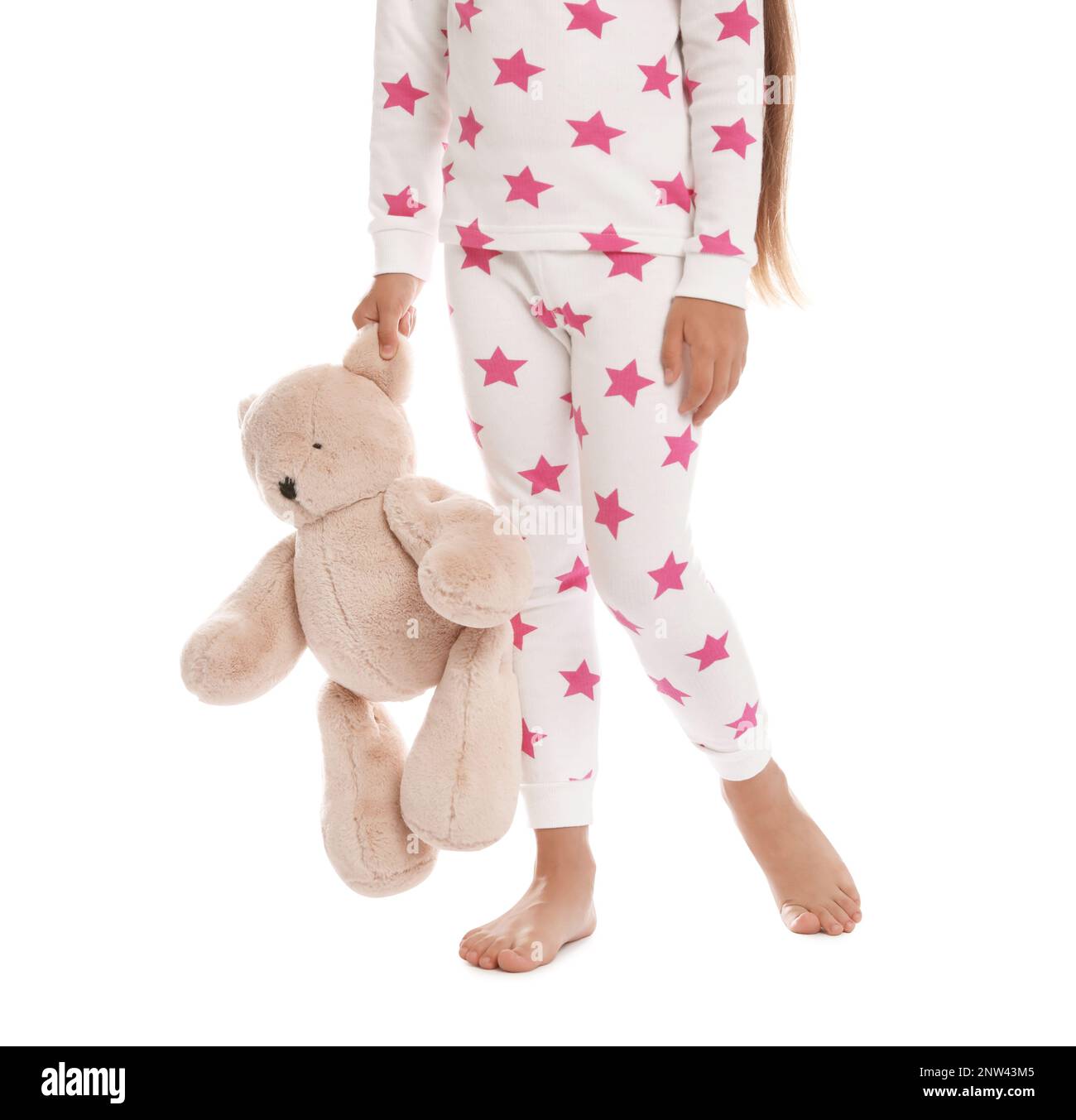 Cute girl wearing pajamas with teddy bear on white background Stock ...