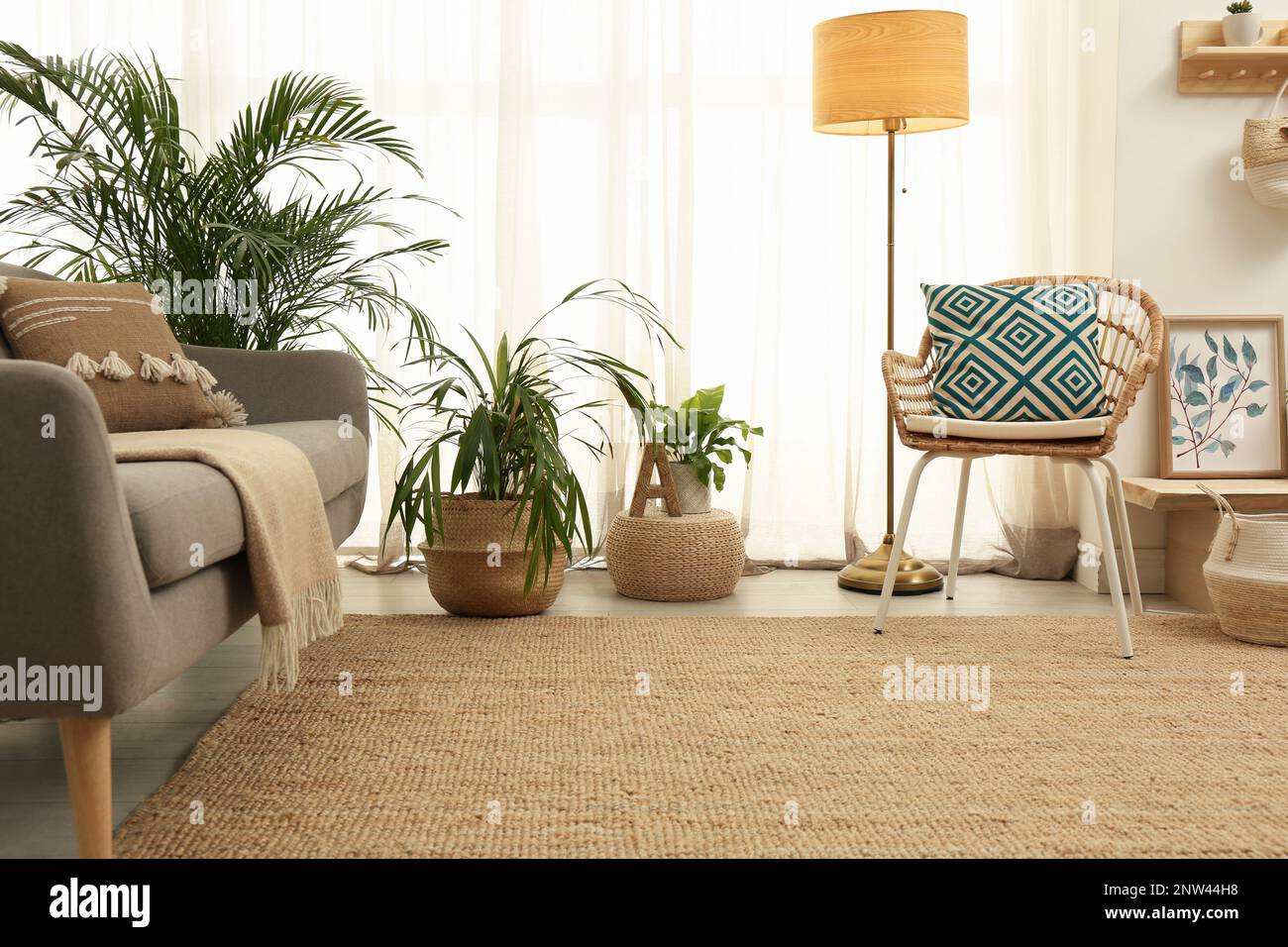 Light living room with boho decor. Interior design Stock Photo - Alamy