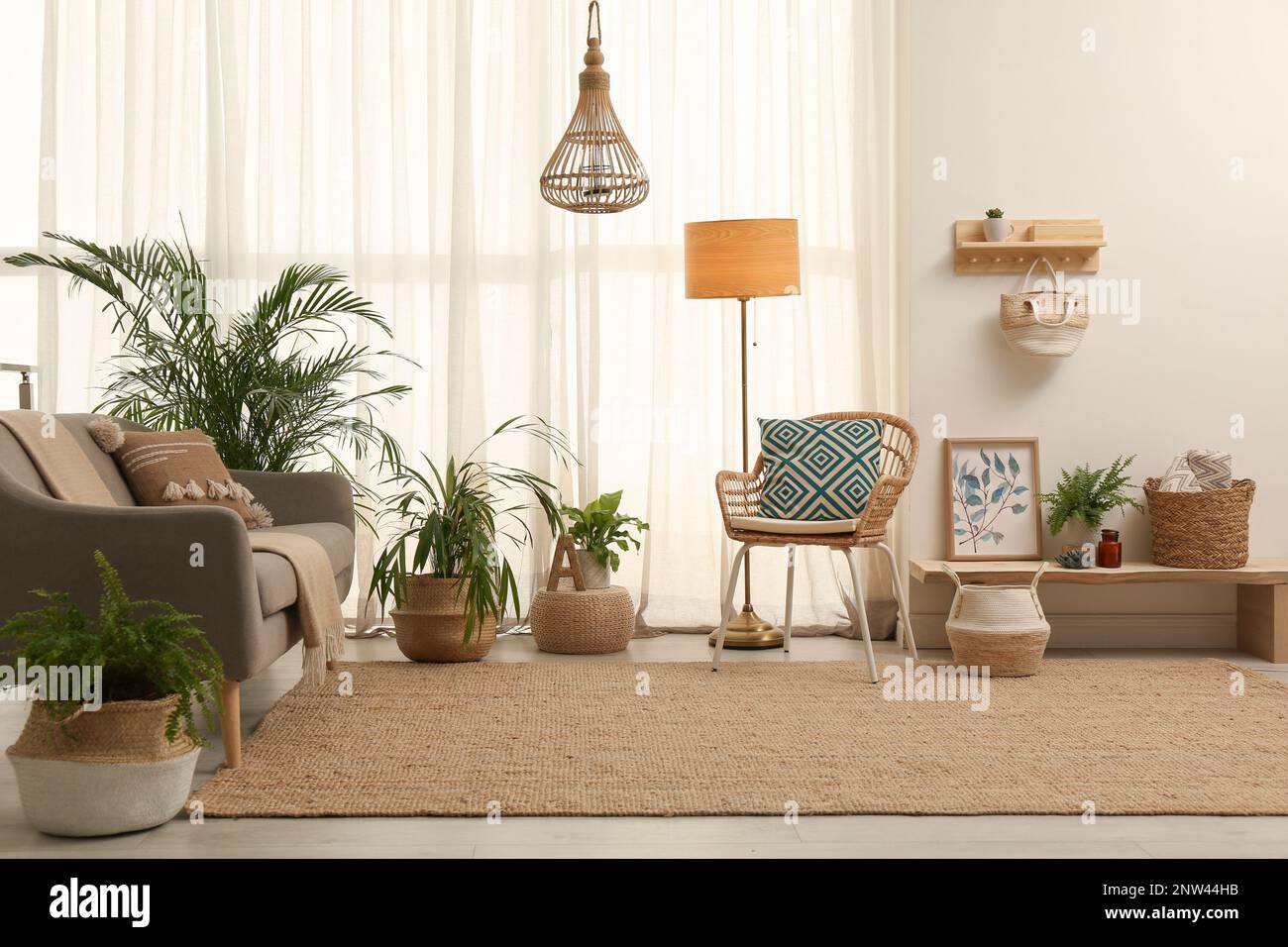 Light living room with boho decor. Interior design Stock Photo - Alamy