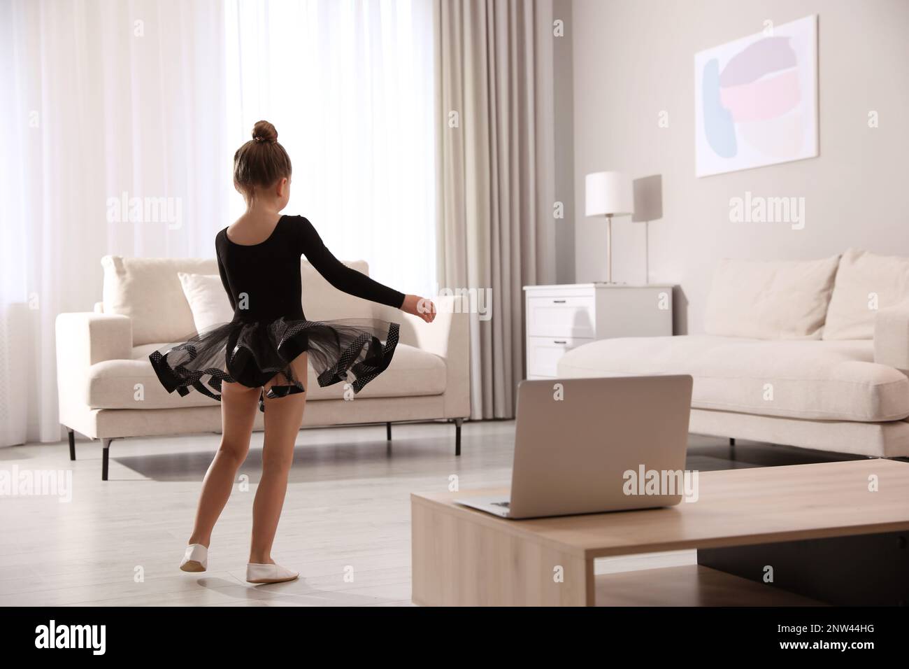 Cute little girl taking online dance class at home, back view Stock ...