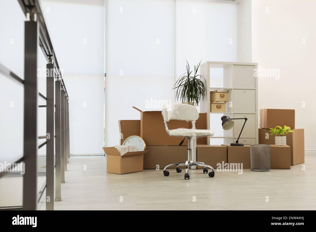 Cardboard boxes with packed stuff in new office. Moving day Stock Photo ...