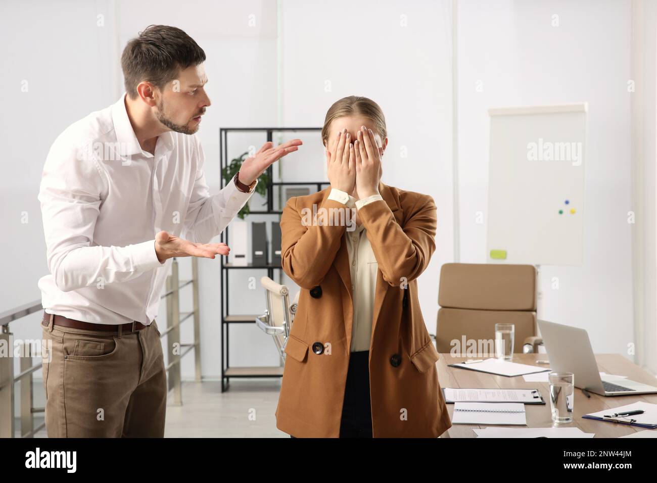 Man scolding woman in office. Toxic work environment Stock Photo - Alamy