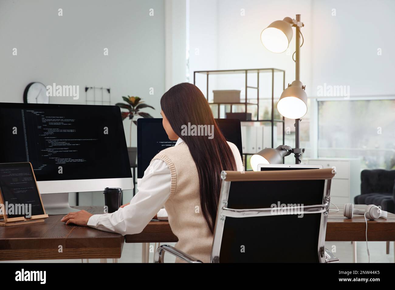 Programmer working at desk in modern office Stock Photo - Alamy
