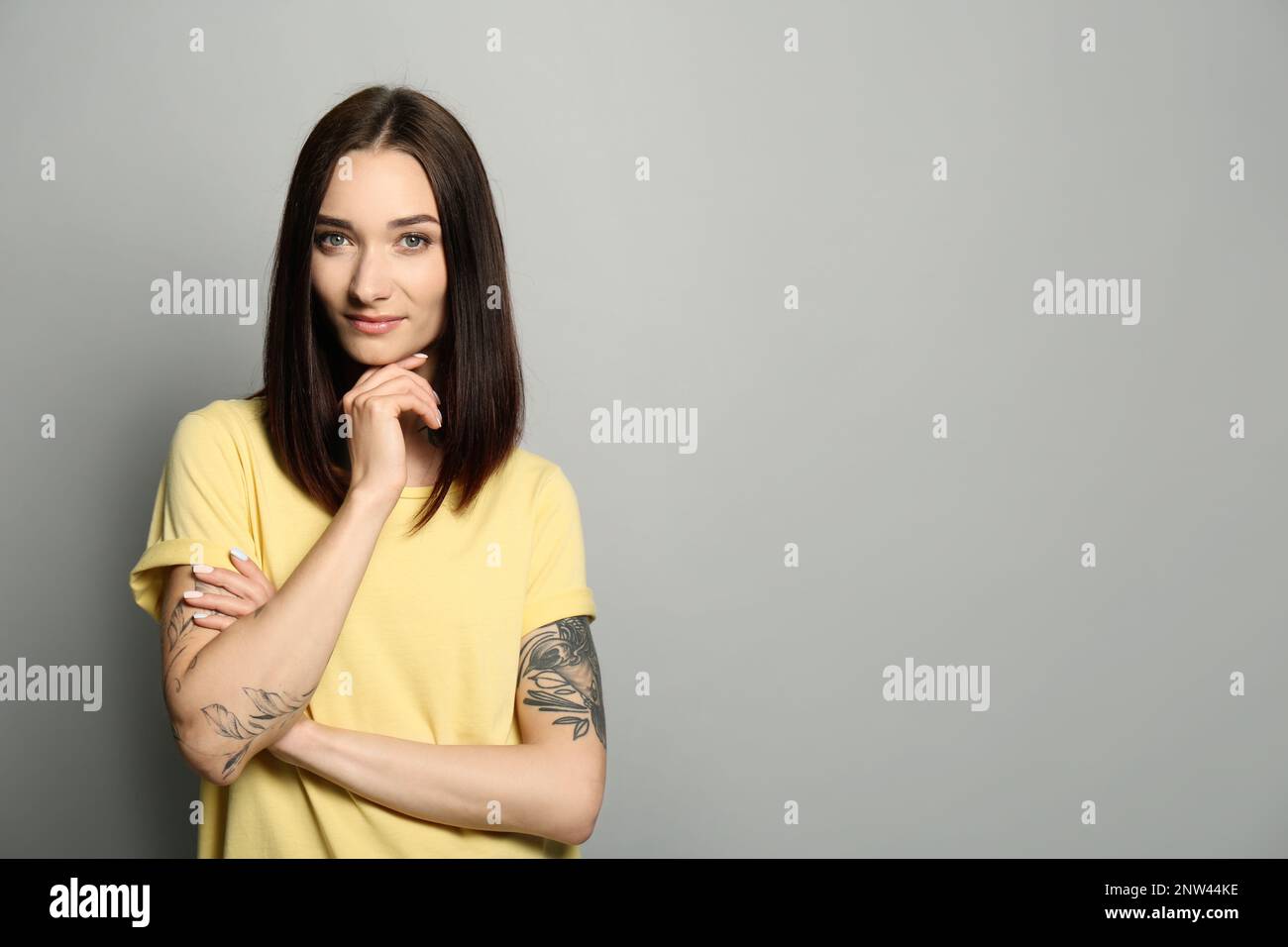 Portrait of pretty young woman with gorgeous chestnut hair on light ...