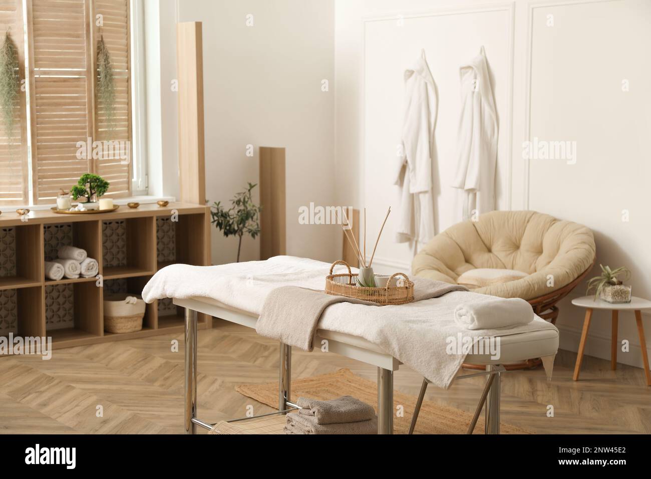 Stylish massage room interior with spa table in salon Stock Photo - Alamy
