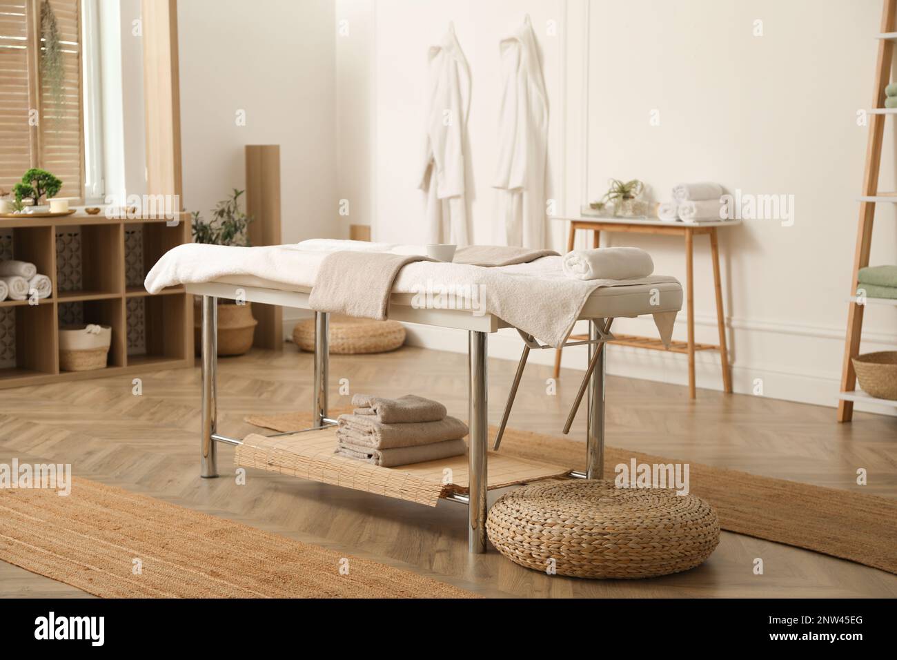Stylish massage room interior with spa table in salon Stock Photo - Alamy