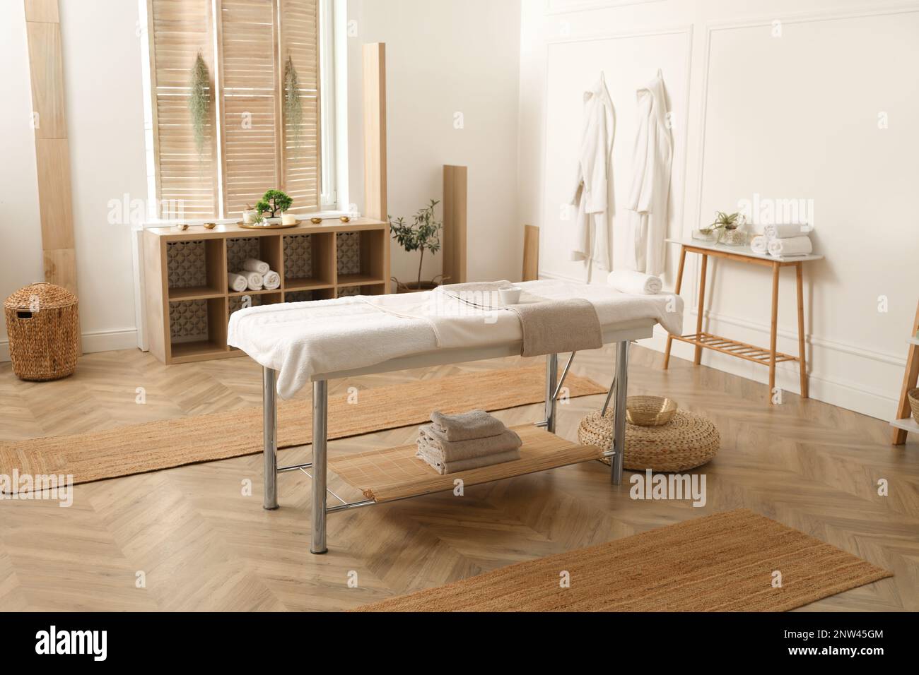 Stylish massage room interior with spa table in salon Stock Photo - Alamy