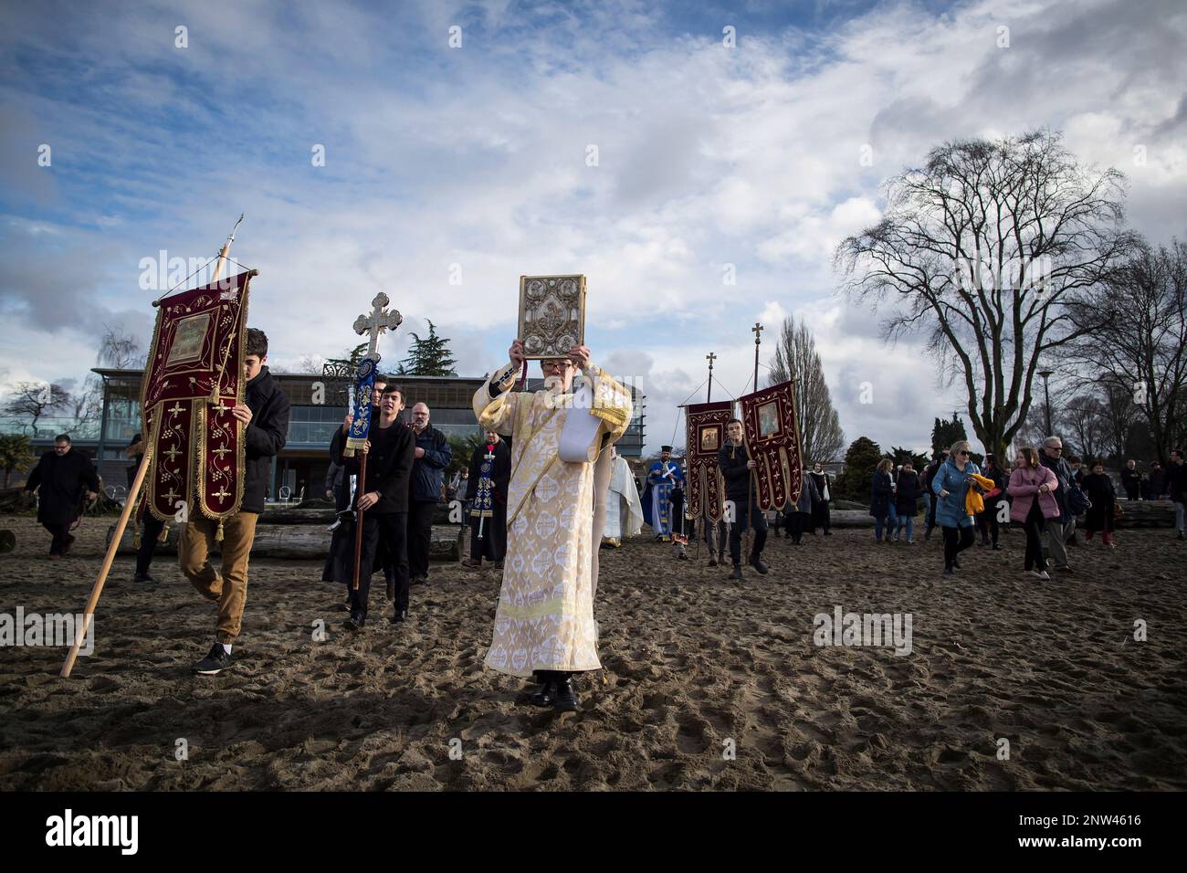 Deacon Peter Choi, centre leads people across the beach and to the ...