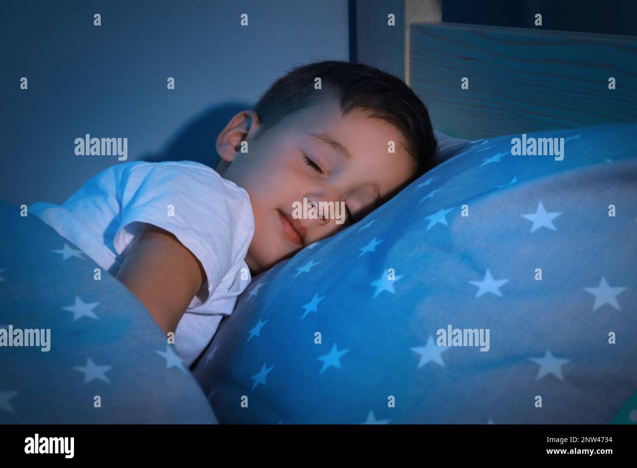 Cute little boy sleeping in comfortable bed Stock Photo - Alamy