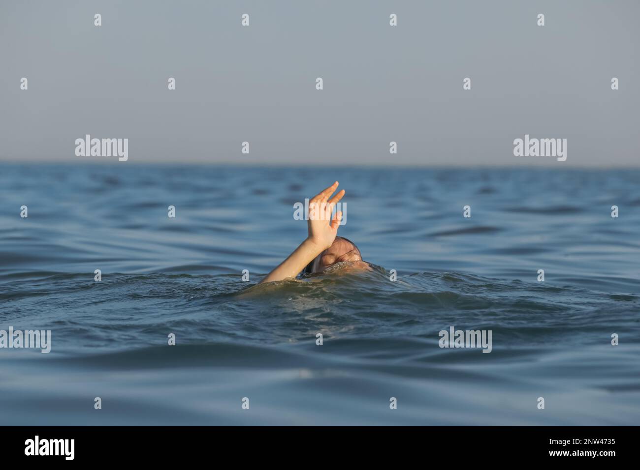 Drowning woman reaching for help in sea Stock Photo - Alamy