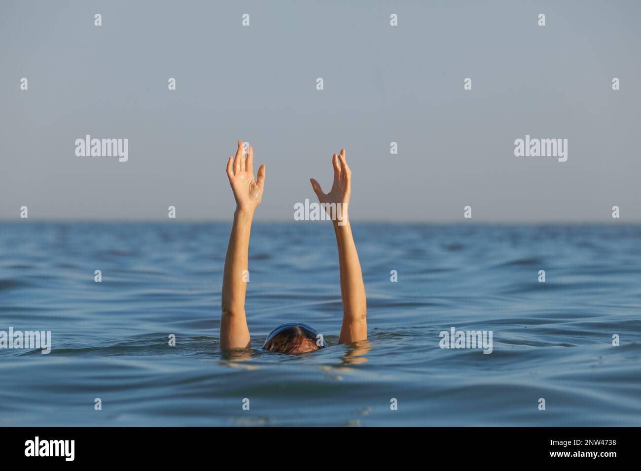 Drowning woman reaching for help in sea Stock Photo - Alamy
