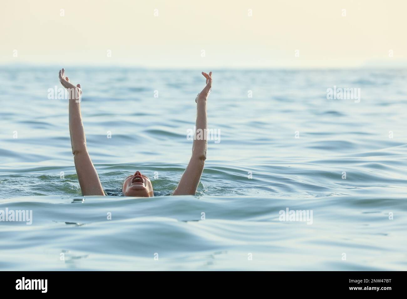 Drowning woman reaching for help in sea Stock Photo - Alamy
