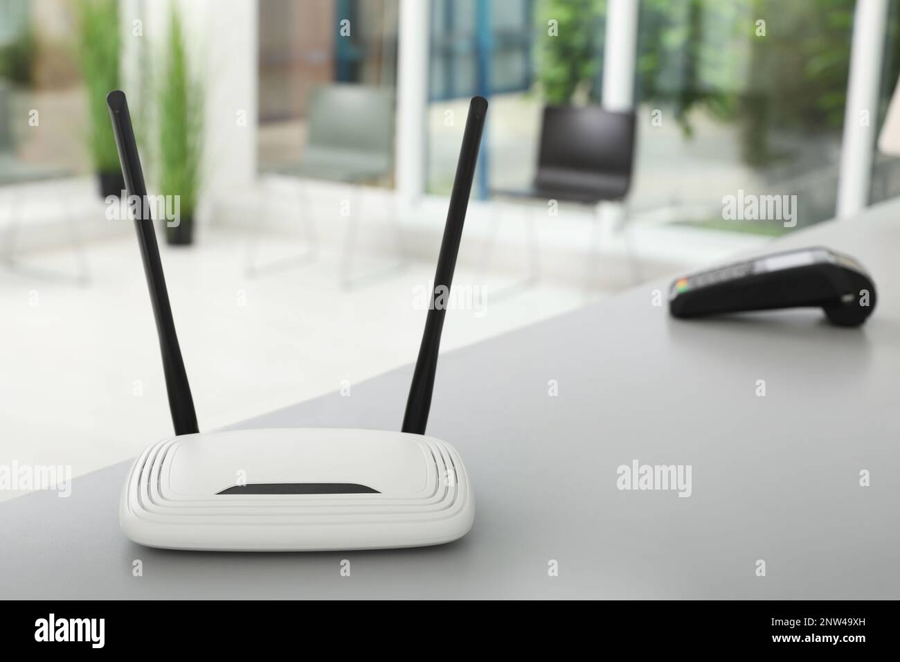 Modern Wi-Fi router on grey table indoors, space for text Stock Photo - Alamy