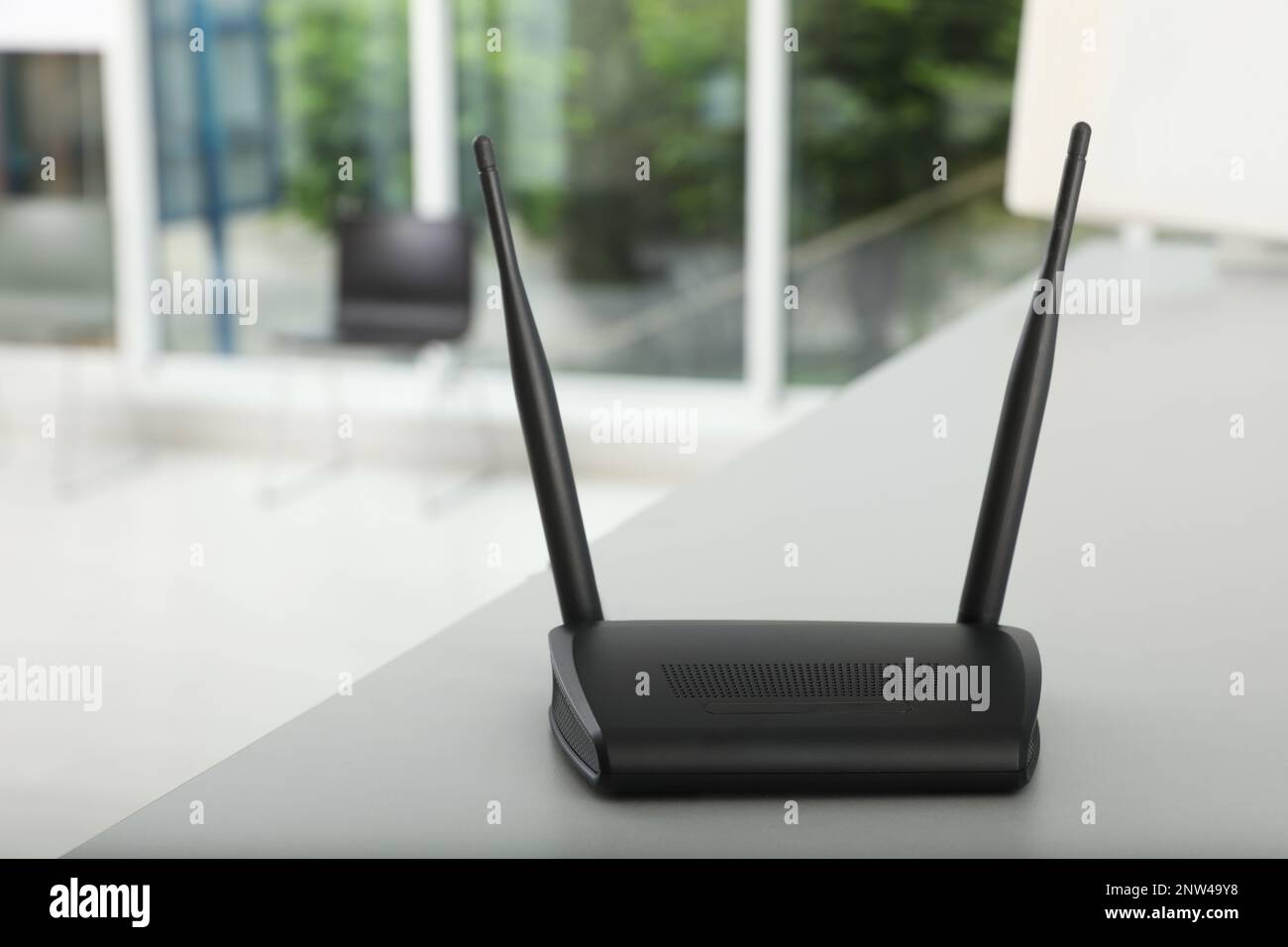 Modern Wi-Fi router on grey table indoors, space for text Stock Photo ...