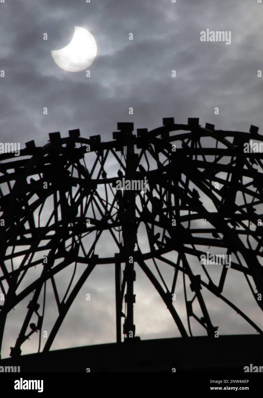 A photo shows a partial solar eclipse above the Atomic Bomb Dome in ...