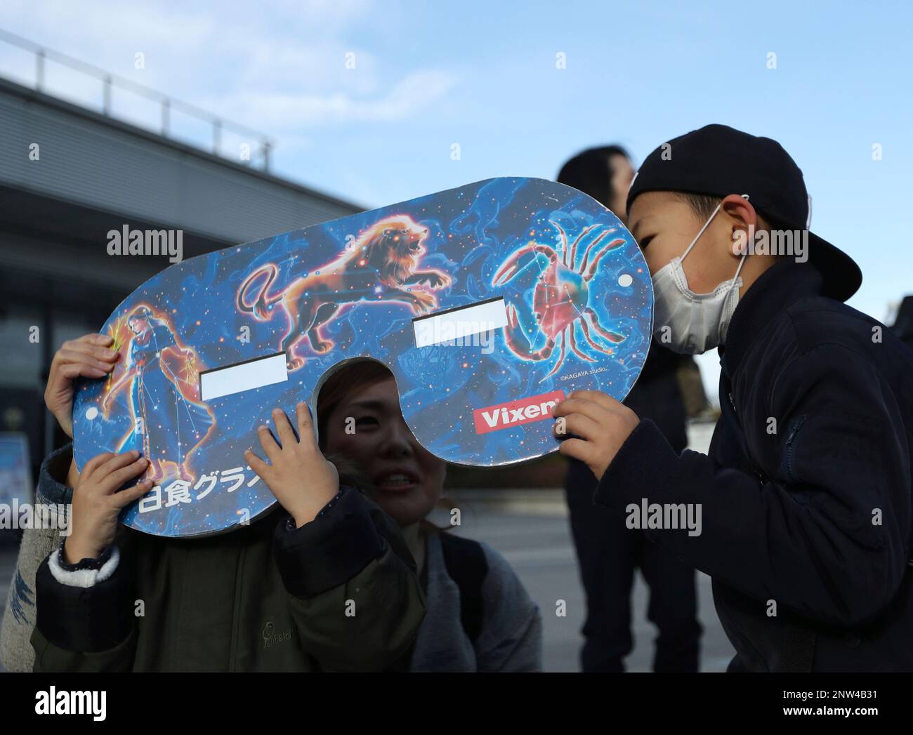 People observe a partial solar eclipse at Tokyo Skytree in Sumida Ward ...