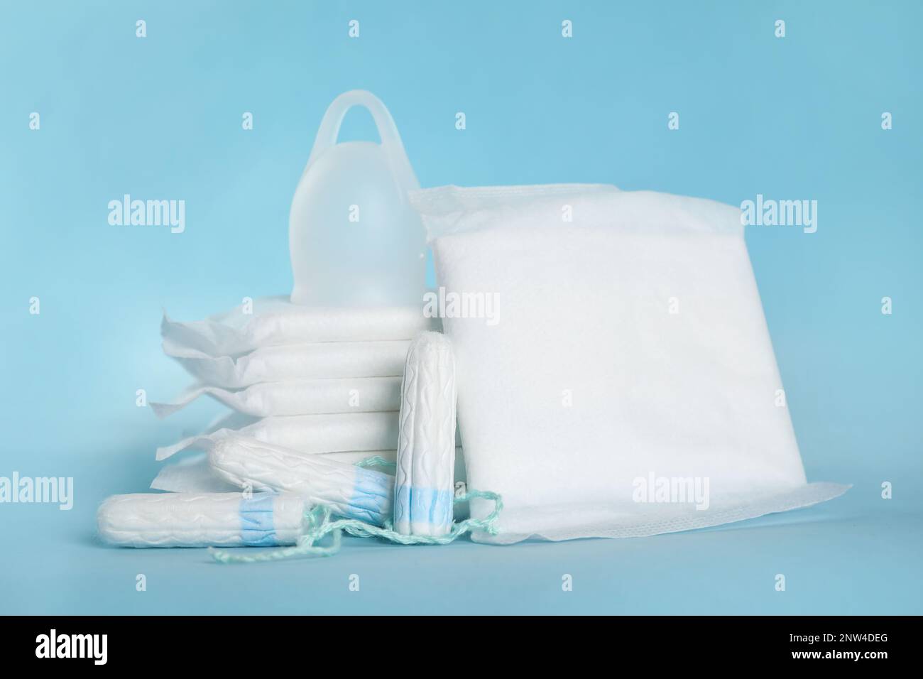 Menstrual pads and other hygiene products on light blue background ...