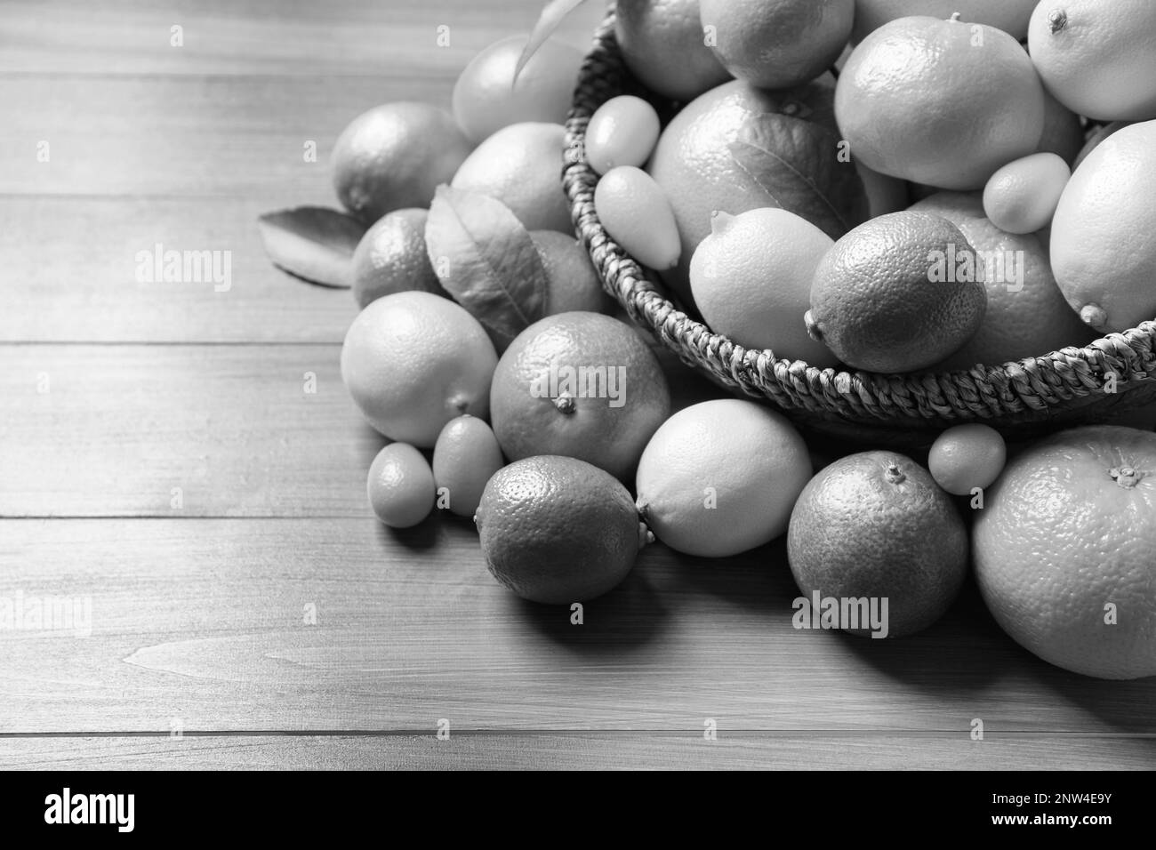 Different citrus fruits on wooden table. Black and white tone Stock ...