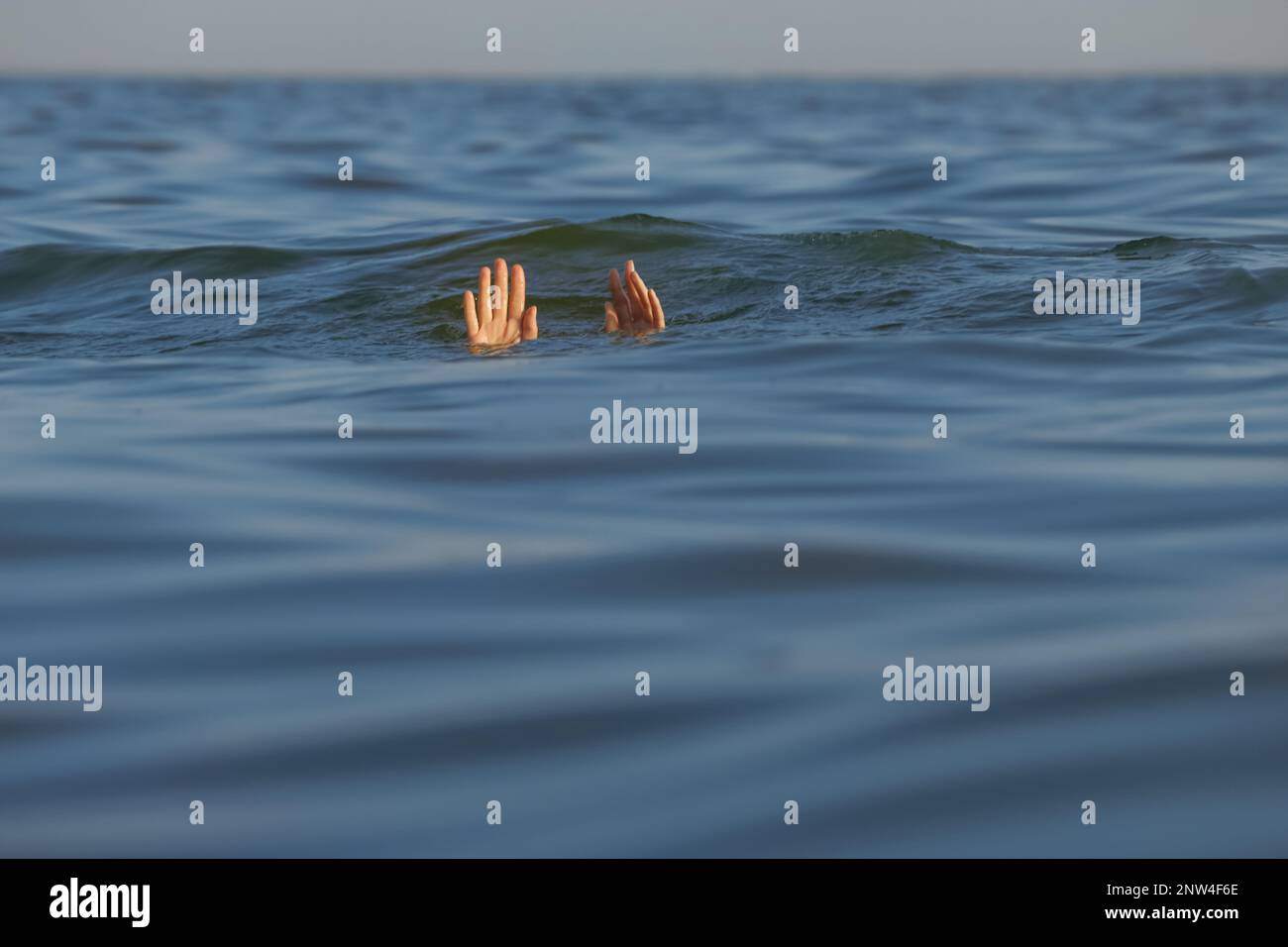 Drowning woman reaching for help in sea Stock Photo - Alamy