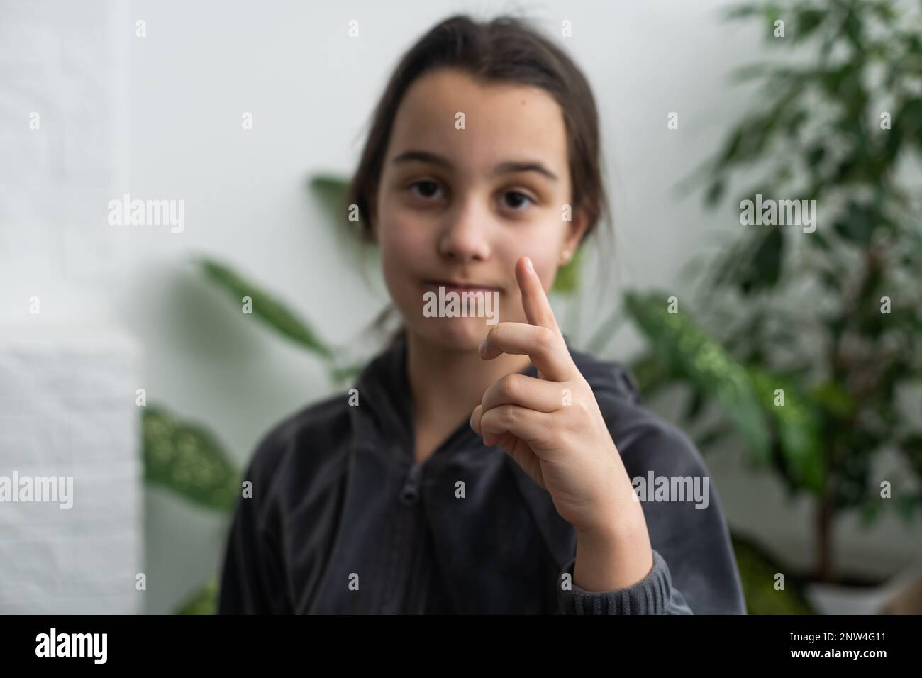 A smiley teenage girl hand sign Stock Photo - Alamy