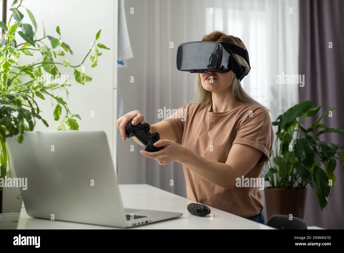 Woman in VR headset looking up at the objects in virtual reality. VR is ...