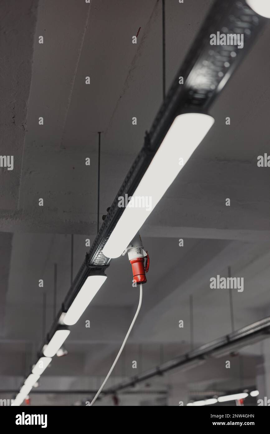 Hanging LED light bulb on ceiling of office building, industrial ...