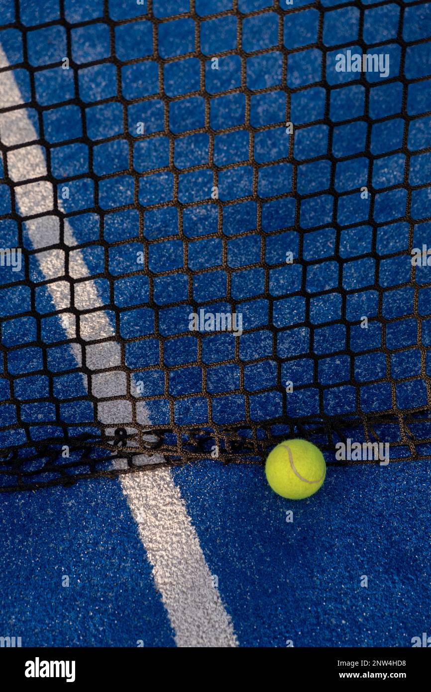 paddle tennis ball in the net of a blue paddle tennis court Stock Photo ...