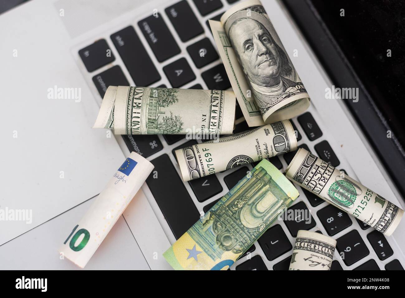 Money on computer keyboard. roll Stock Photo - Alamy
