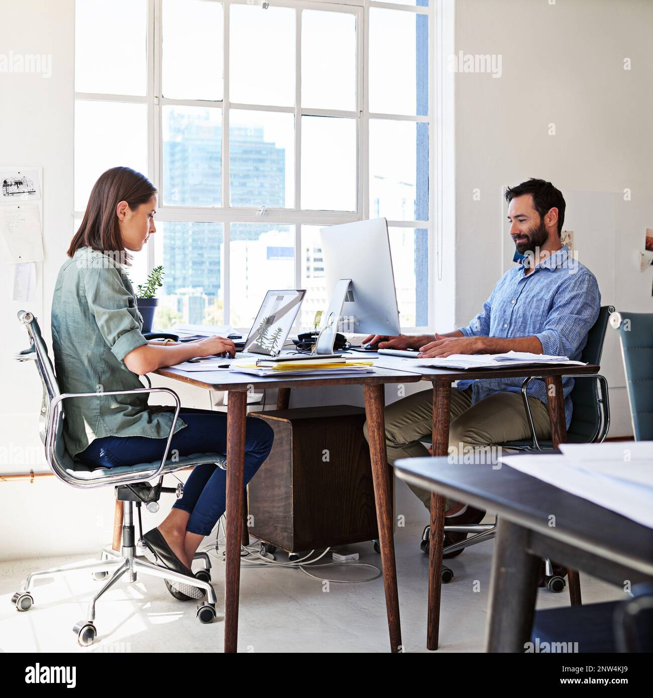 Coworkers, concentration and man and woman in coworking space at ...