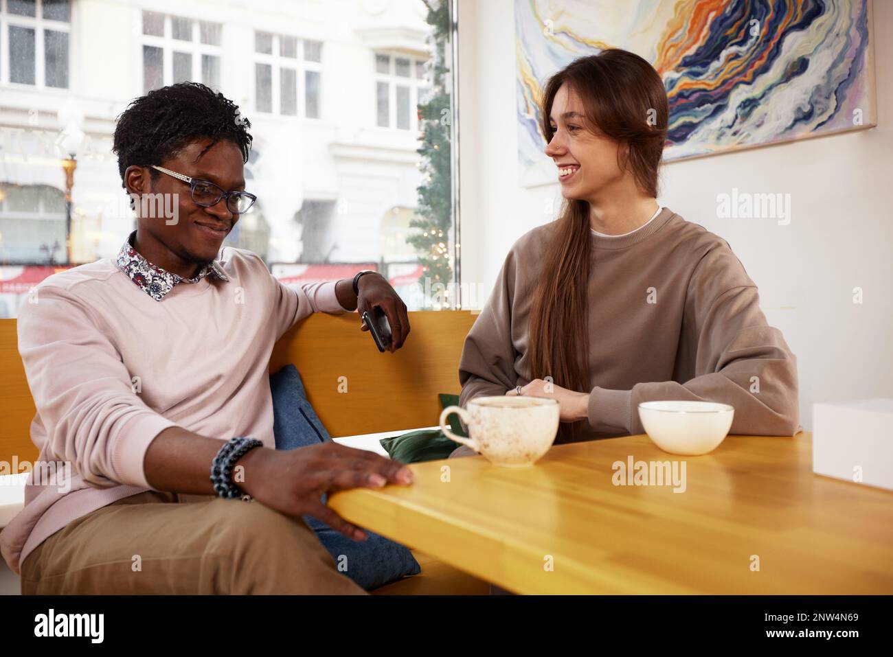 Group of multiracial young people sharing ideas and having friendly ...