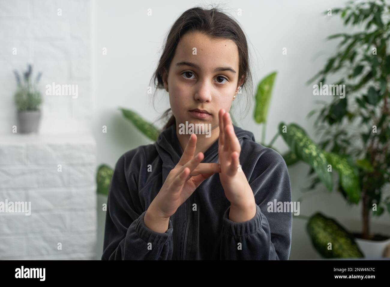 A smiley teenage girl hand sign Stock Photo - Alamy