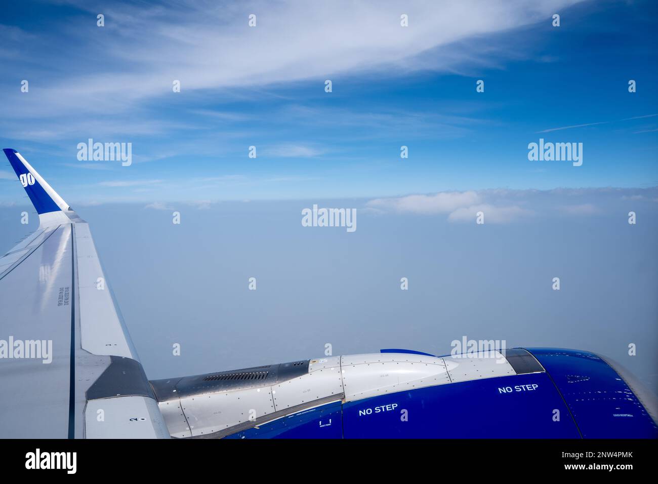 A plane in the air, taken from inside the airplane. Cloud view from ...