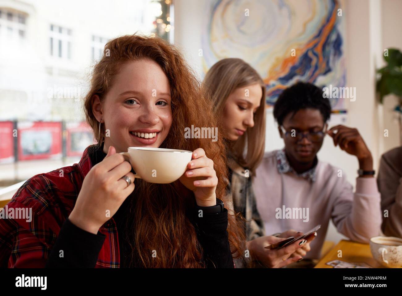 Group of multiracial young people sharing ideas and having friendly ...