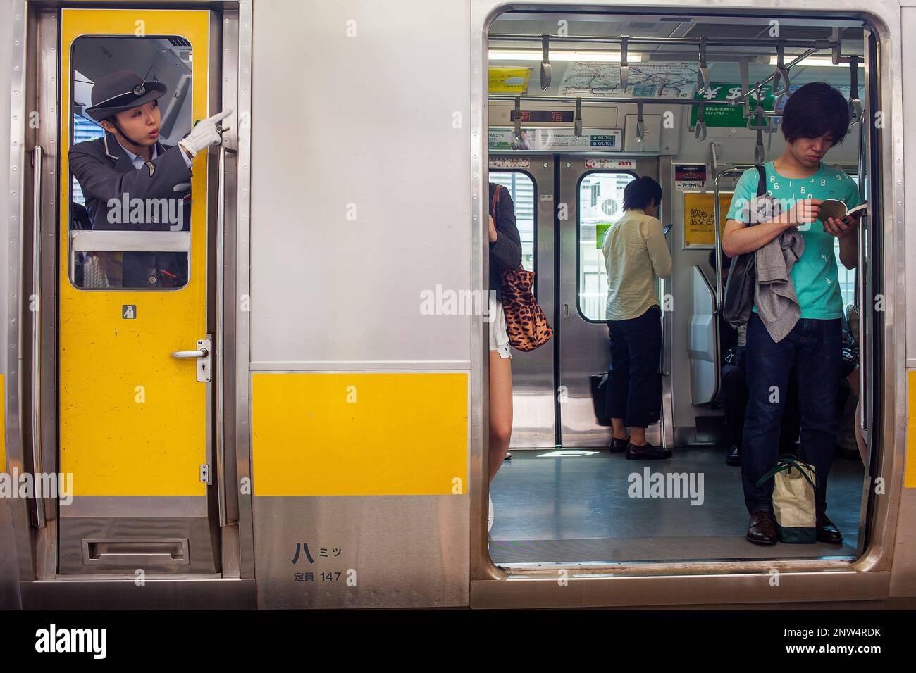 Train conductor and passengers. Shinjuku Railway station.Chuo Sobu Line ...