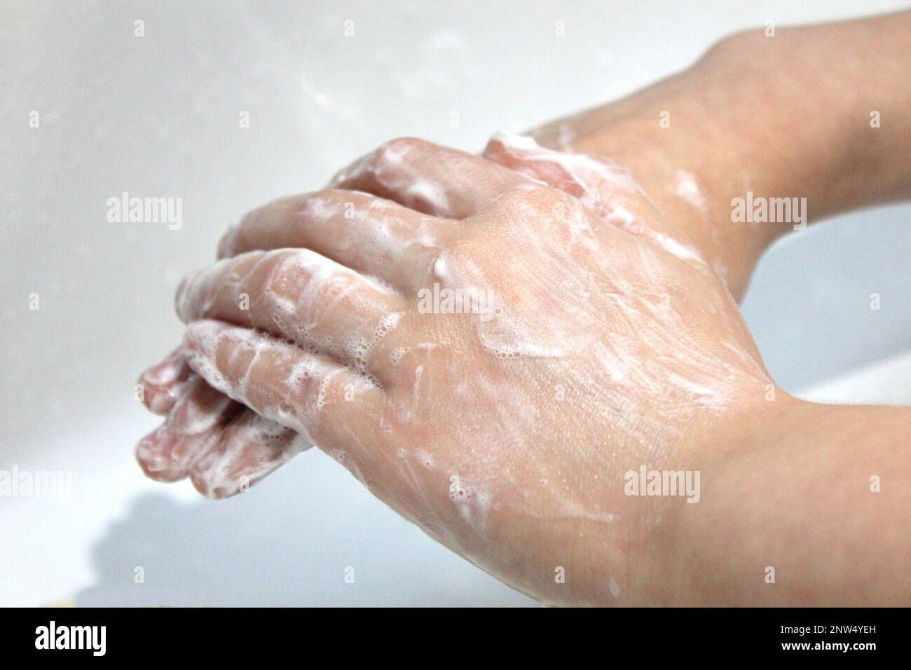 Teen's hands lather each other over the sink. Concept of hygiene Stock ...