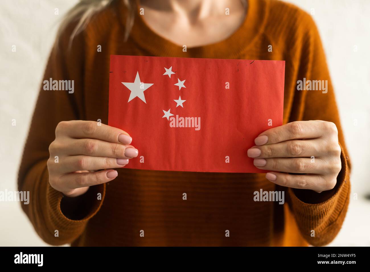 hand holding Chinese flag isolated on white background, template for ...
