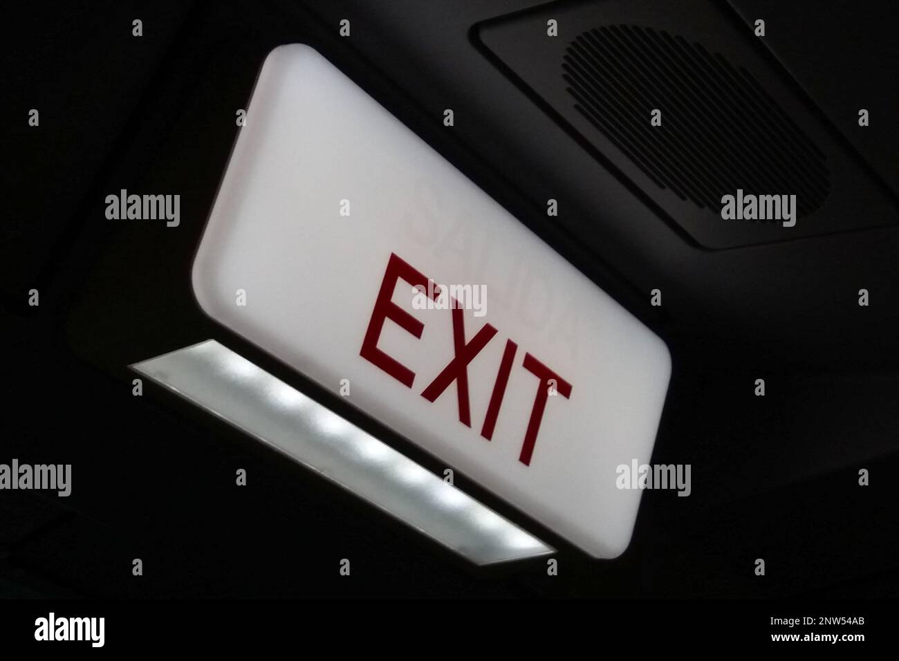 Exit sign on the top of an indoors door of an A330 Stock Photo - Alamy