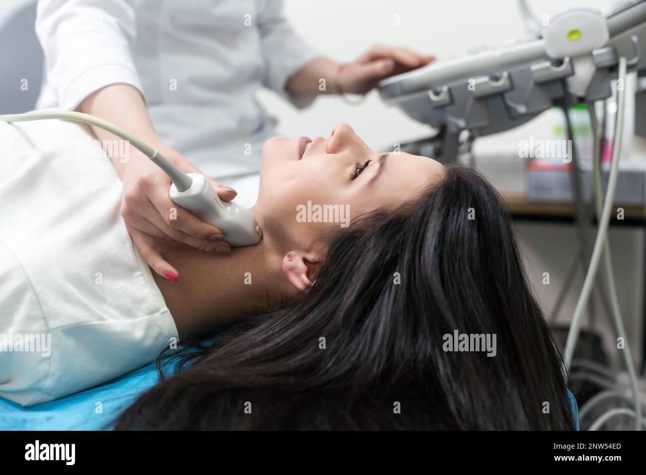 Ultrasound scanning diagnostic of woman thyroid gland in clinic, doctor ...