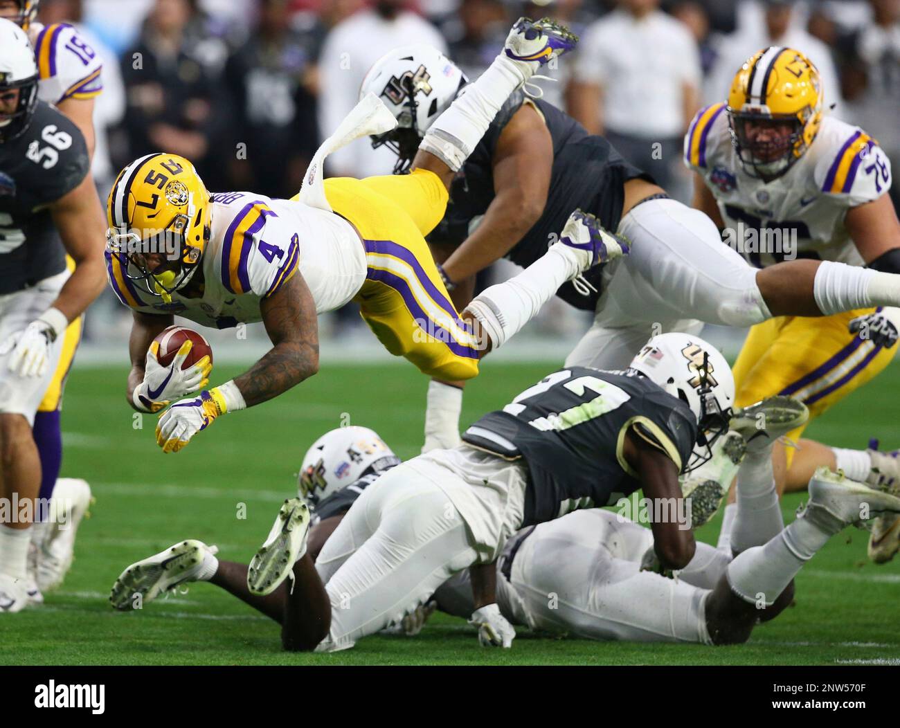LSU running back Nick Brossette (4) gets upended by UCF defensive back ...