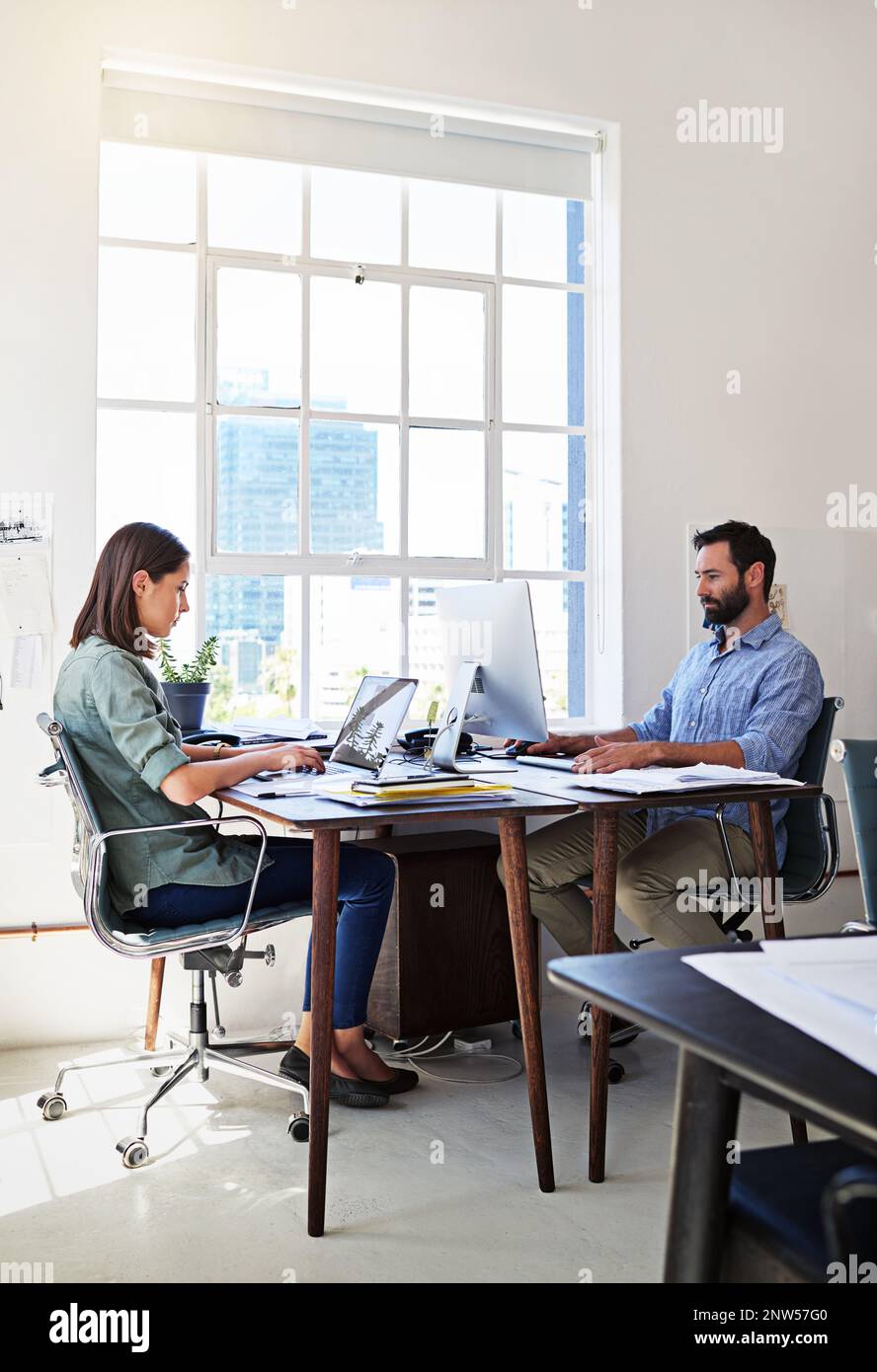 Collaboration, concentration and man and woman in coworking space, team ...